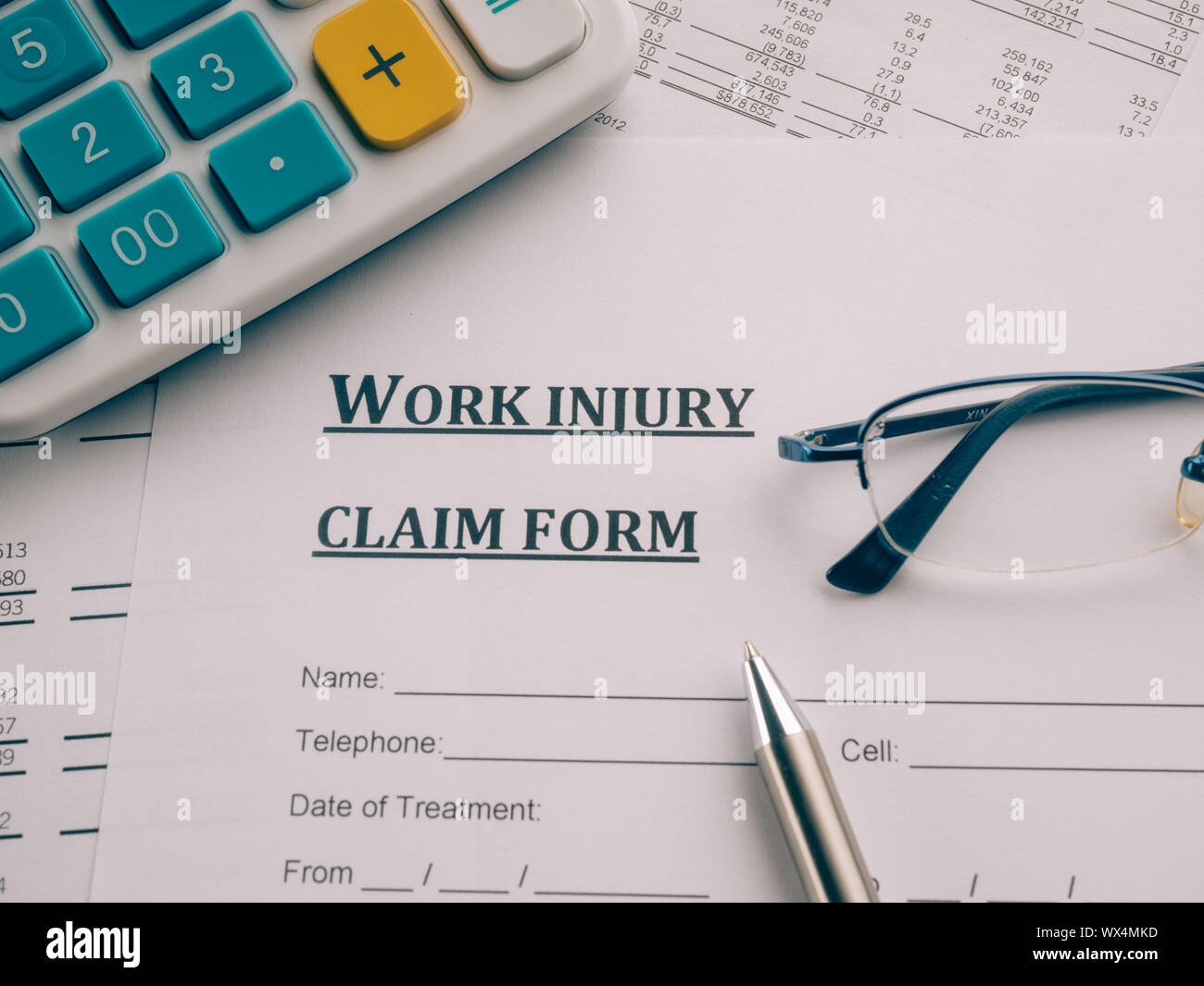 work injury claim form on desk Stock Photo - Alamy