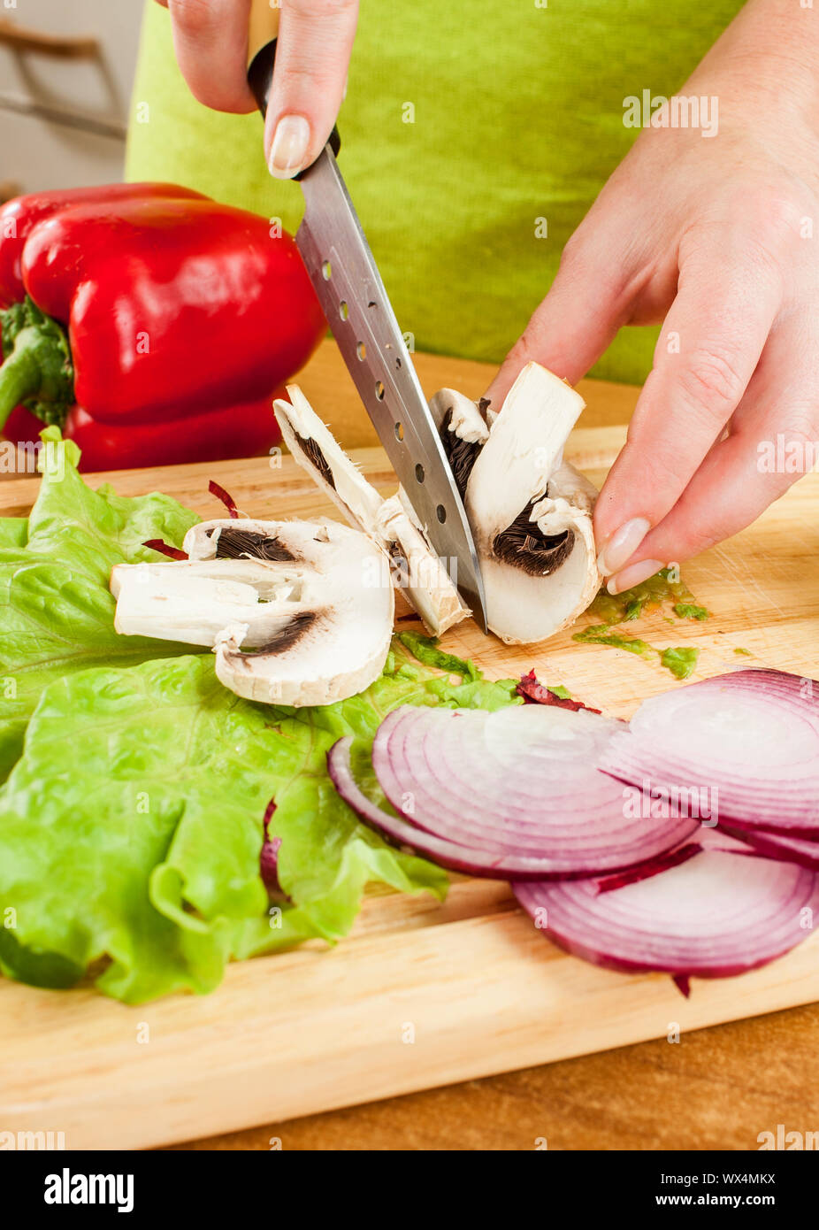 Woman's hands cutting mushroom champignon Stock Photo - Alamy