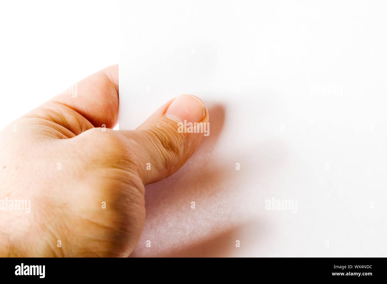 A males hand holding up a white paper with nothing on it (put on your ...