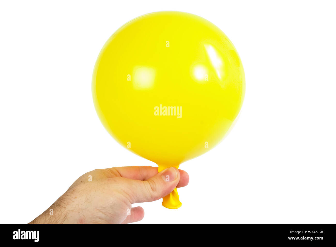 A yellow baloon being held in a hand. Isolated on white with clipping ...