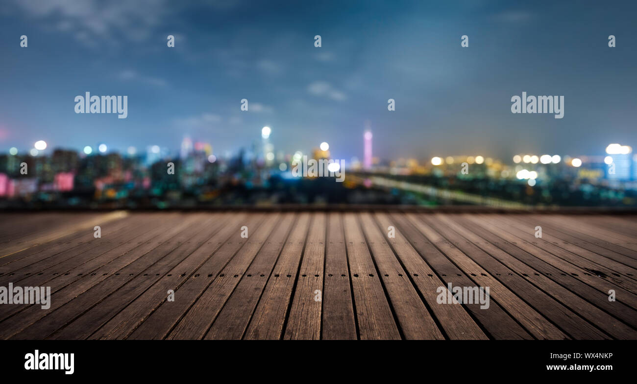 wooden platform and lights of night city Stock Photo - Alamy