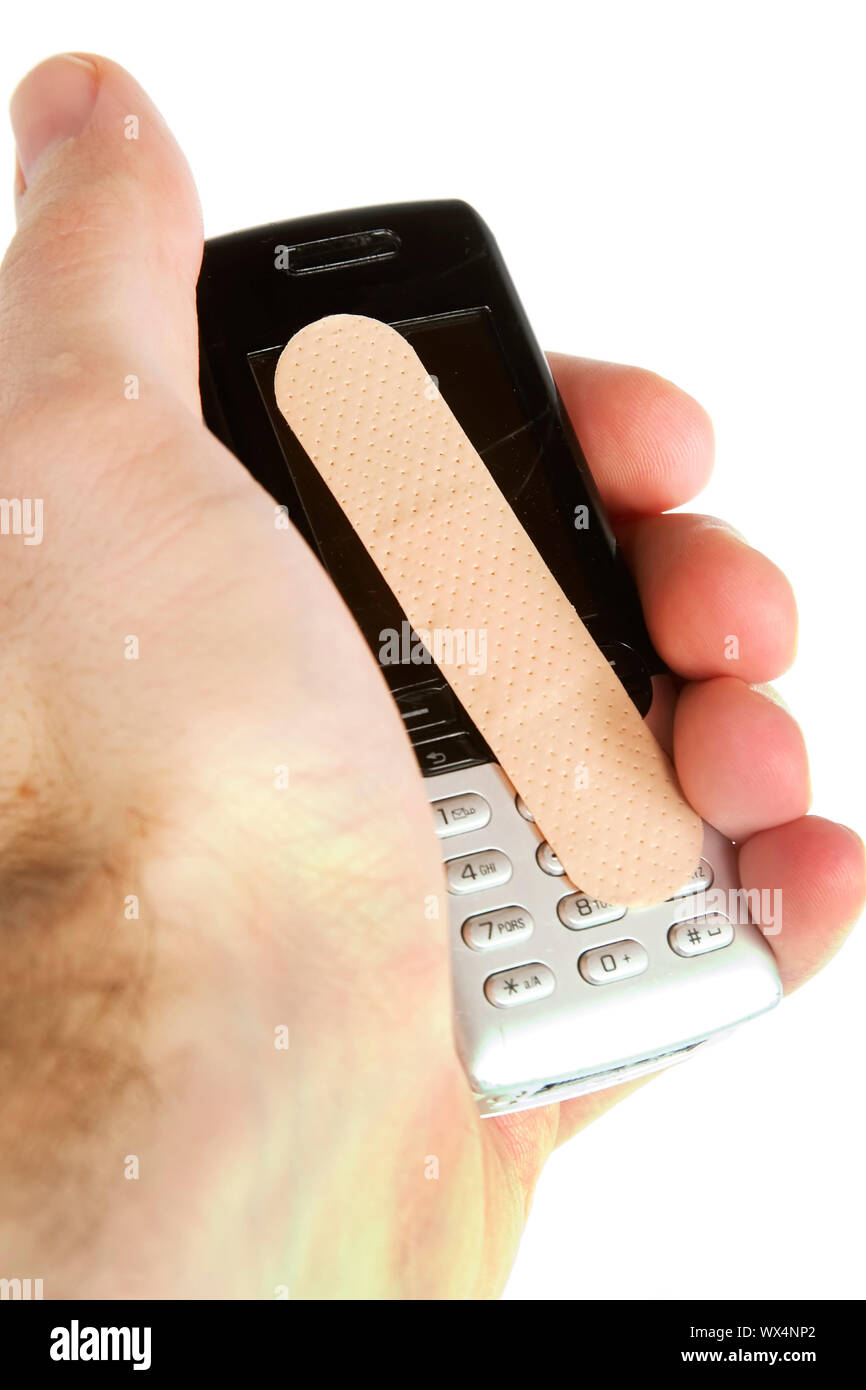 A cell phone with an adhesive bandage being held in a males hand ...