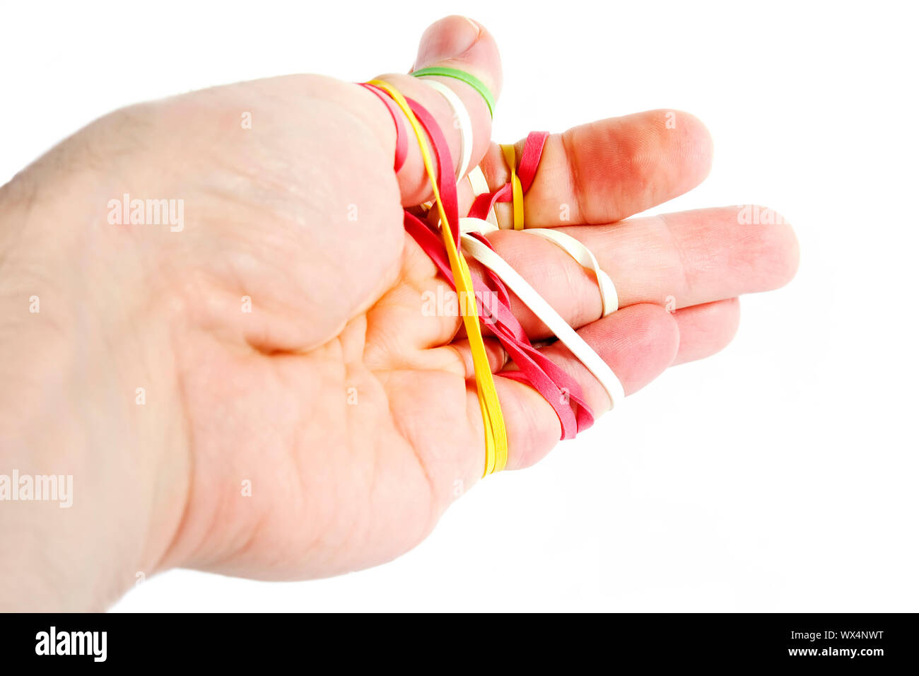 A male hand tangled in a mess of rubber bands. Isolated on white with ...