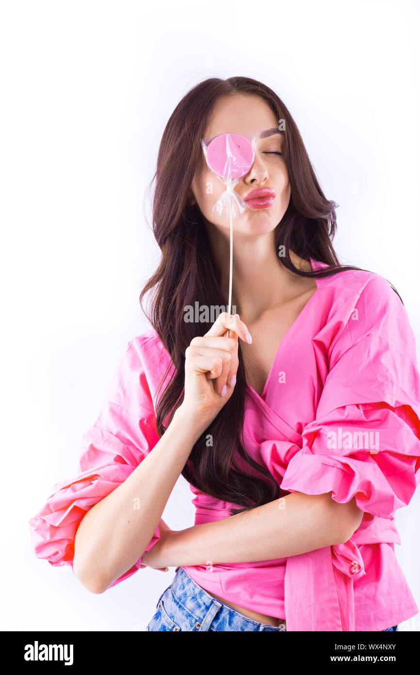 Cheerful Bright Girl in pink clothes with sweet candy on isolated white ...