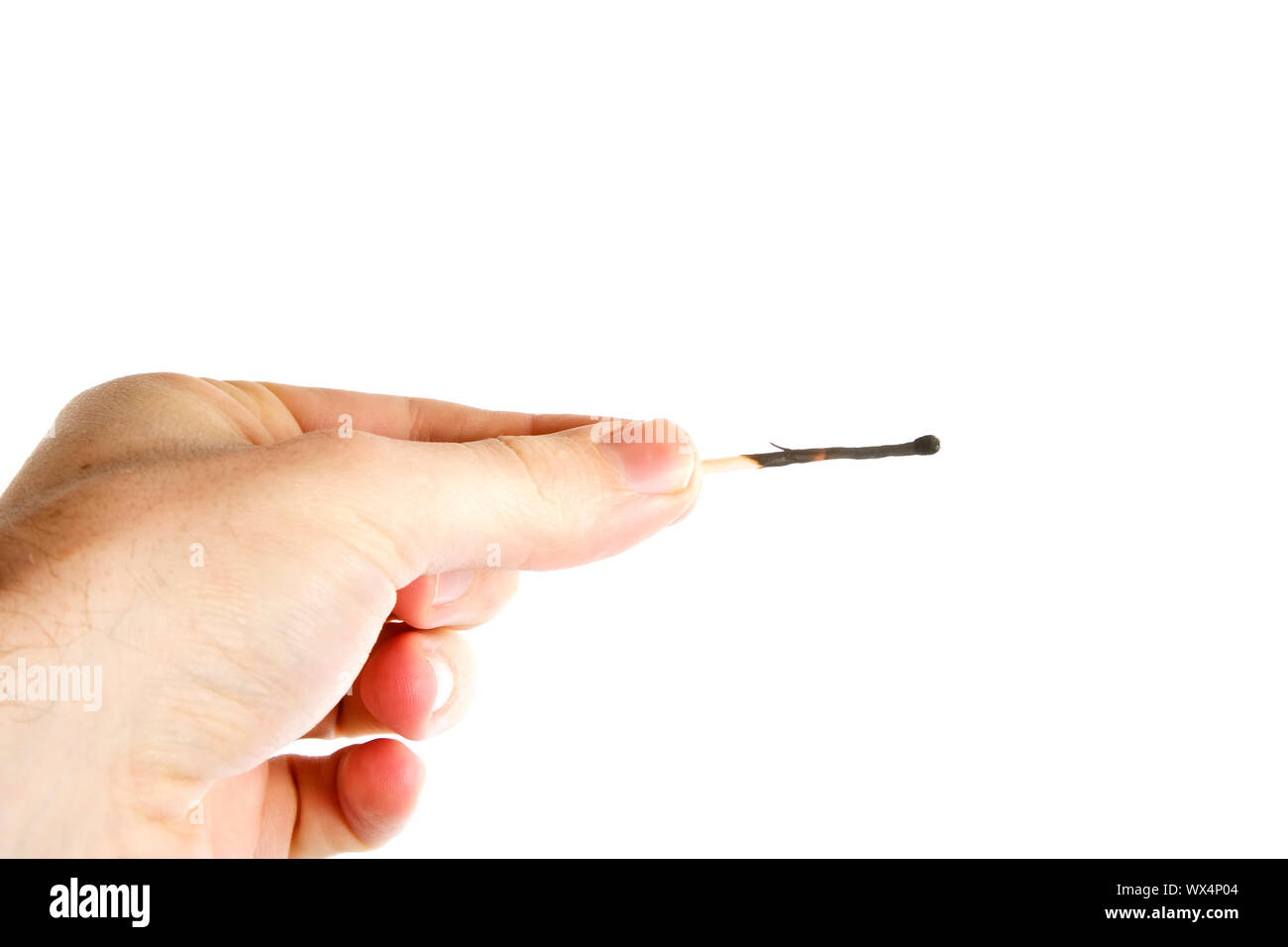 A burned match being held by two fingers delicatly. Isolated on white ...