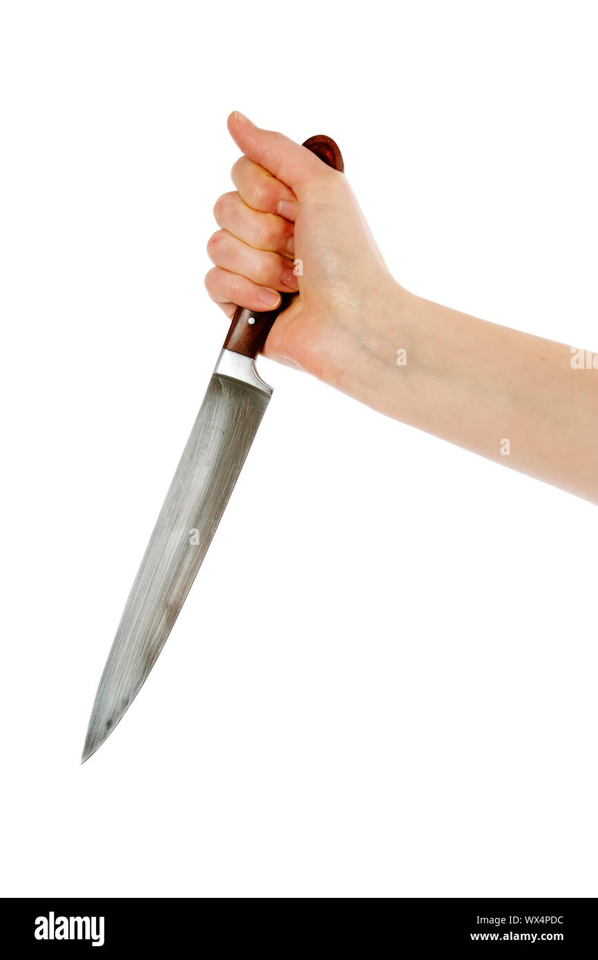 A female hand holding a large butcher knife (in a stabbing grip ...