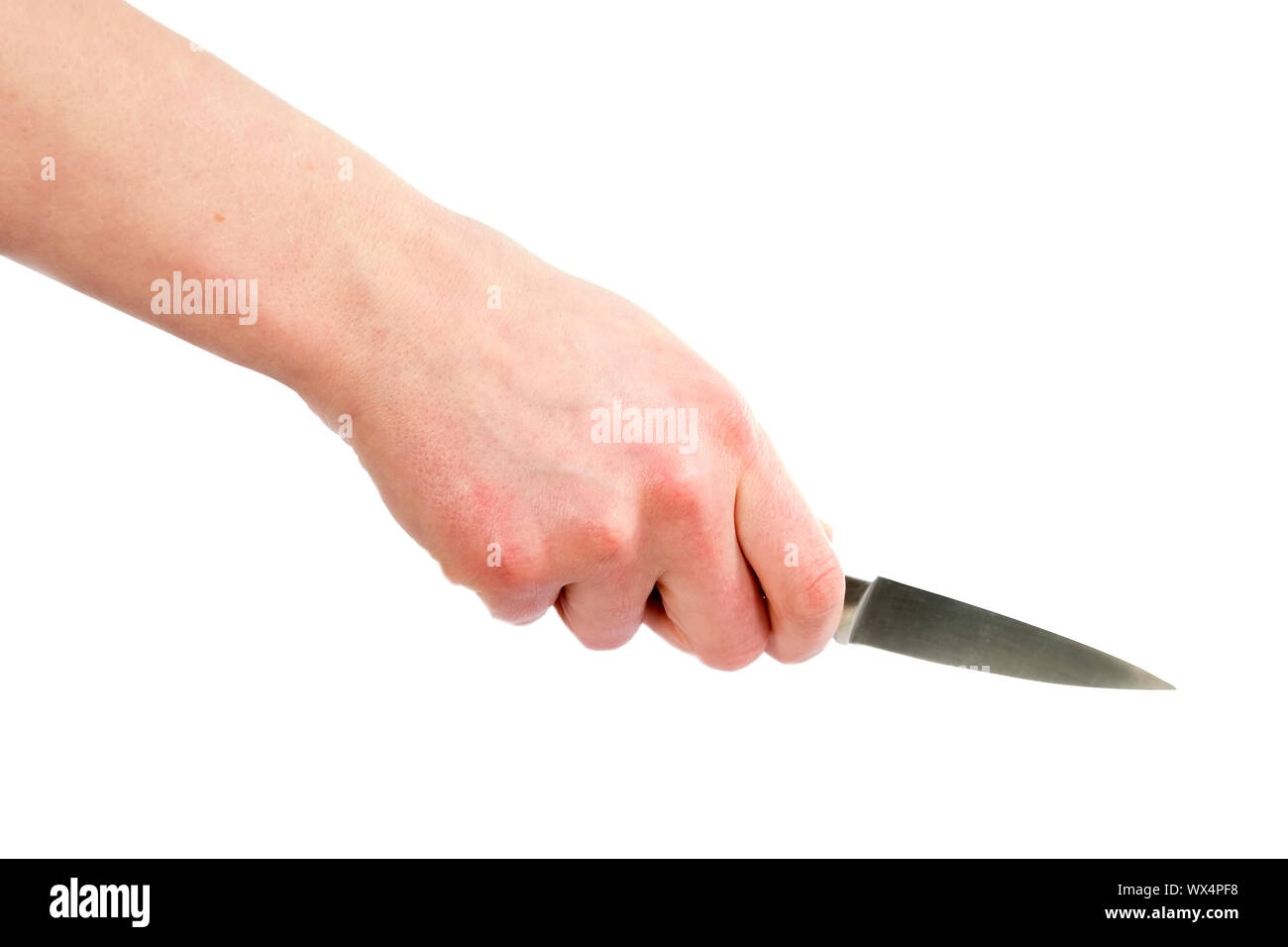 A small pearing knife in a female hand, ready to cut something ...