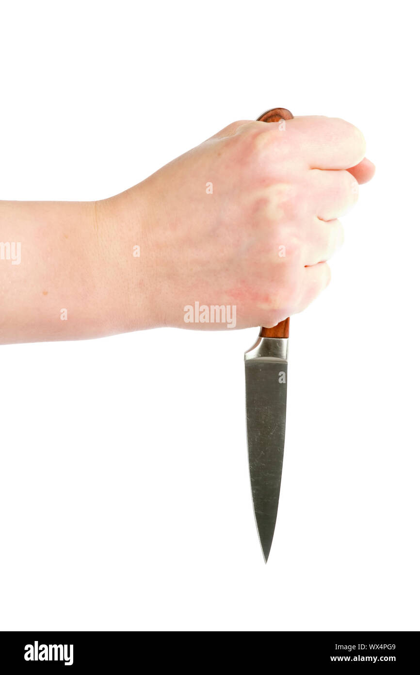 A small pearing knife in the hand of a woman. The knife is held in a ...