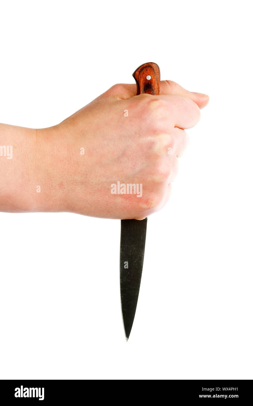 A small pearing knife in the hand of a woman. The knife is held in a ...