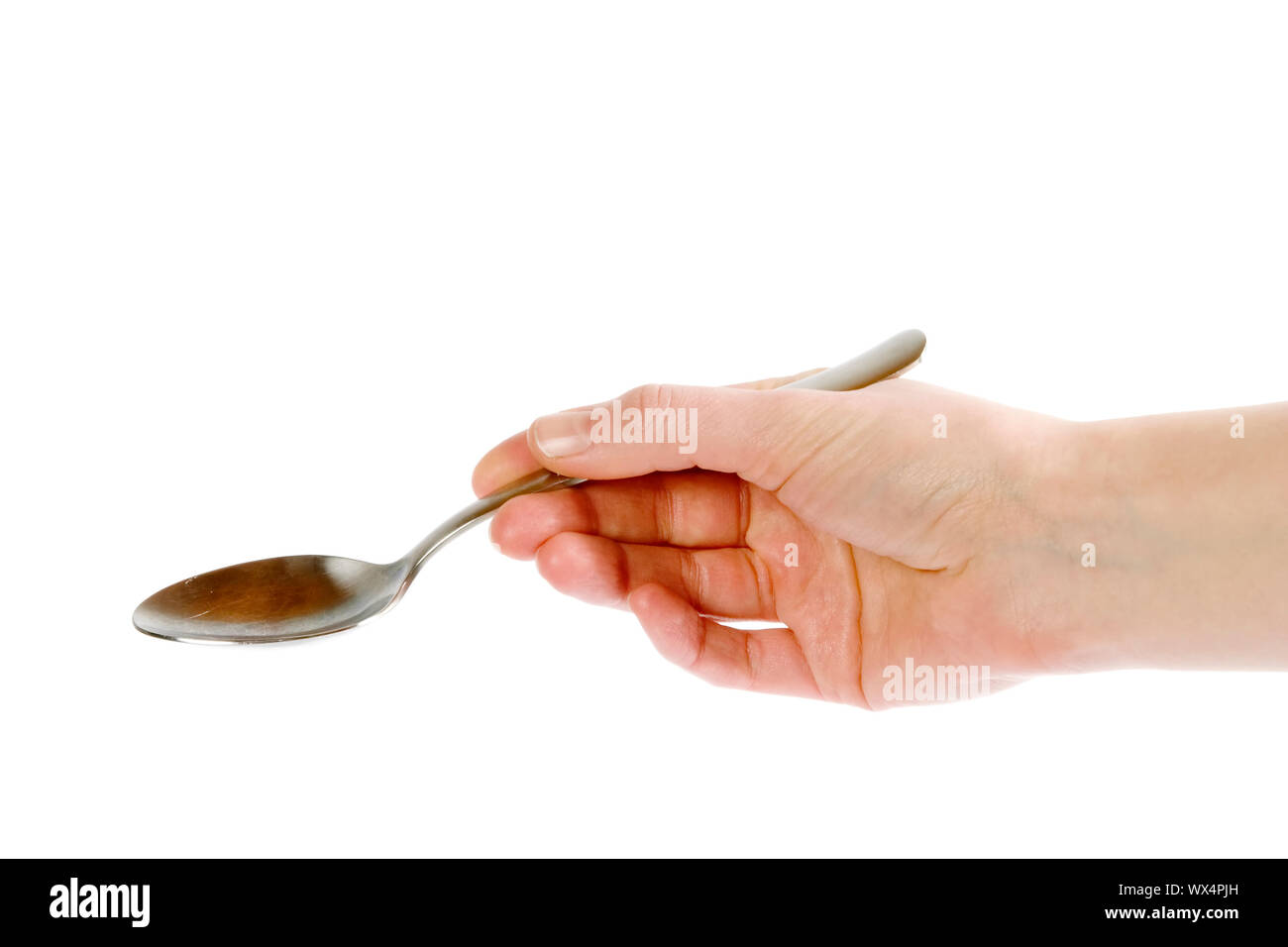 A spoon being held by a female hand. Isolated on white with clipping ...