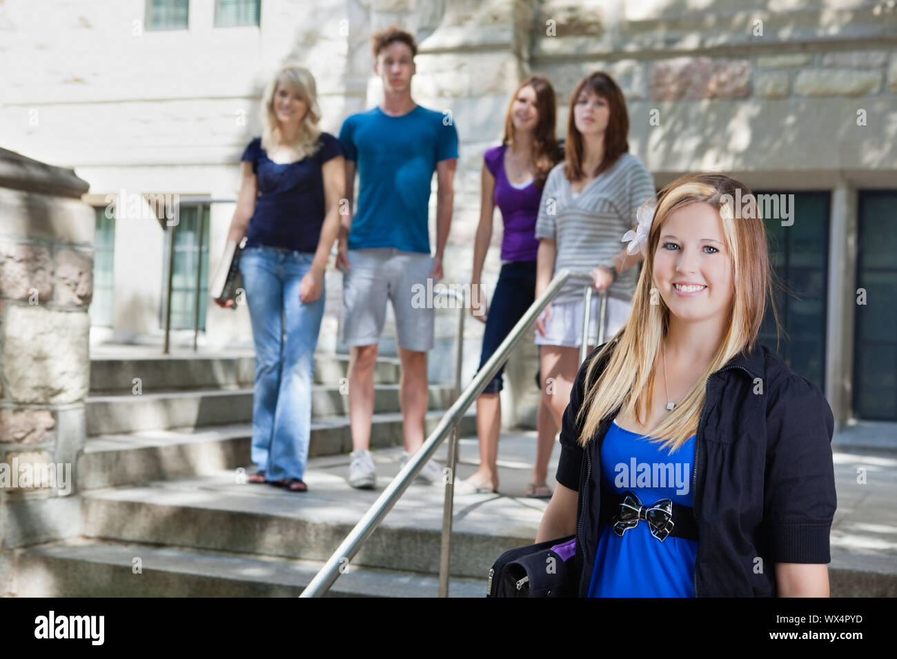 Group of students standing at college building Stock Photo - Alamy