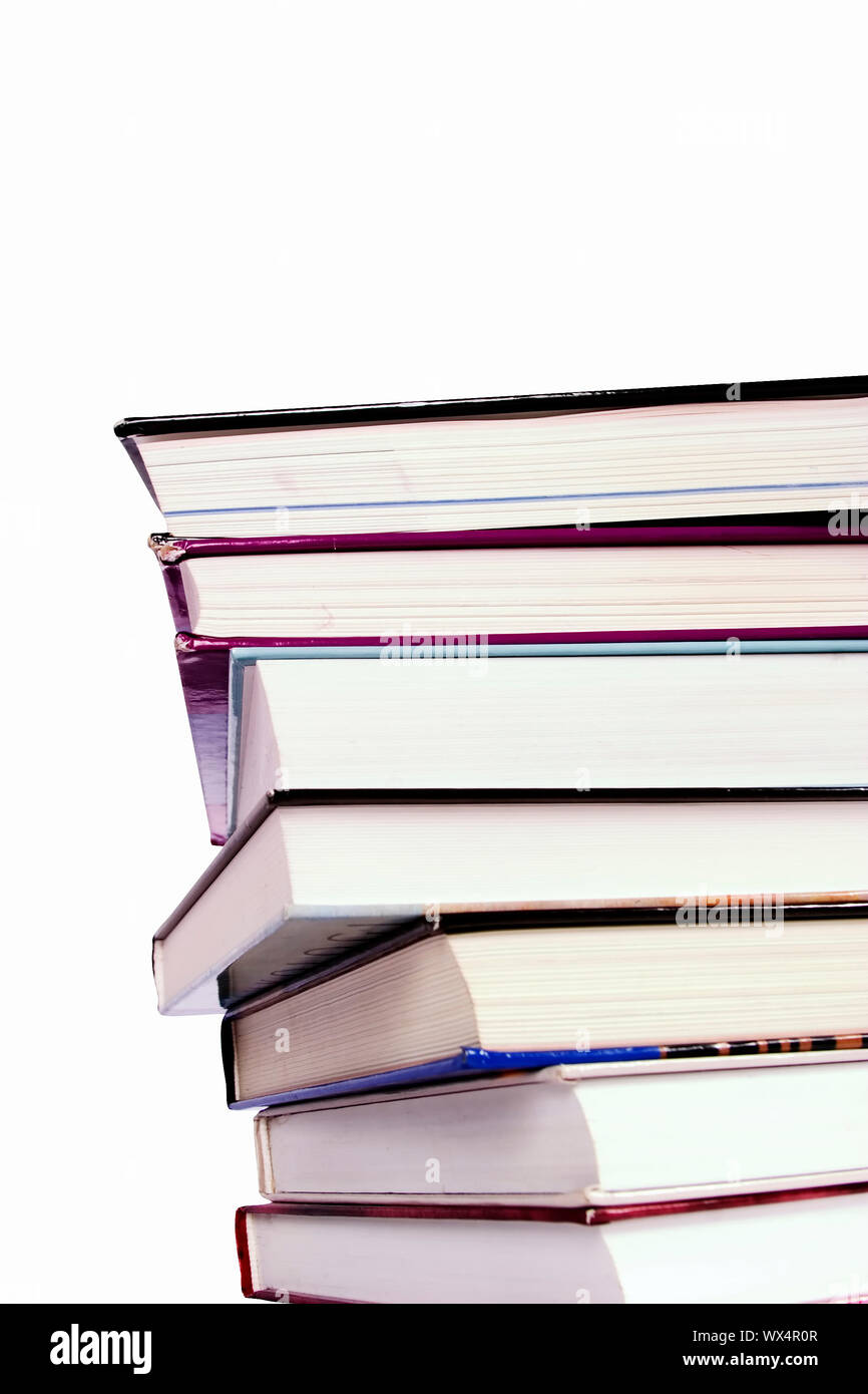 An endless stack of hard cover text books piled high, isolated on white ...
