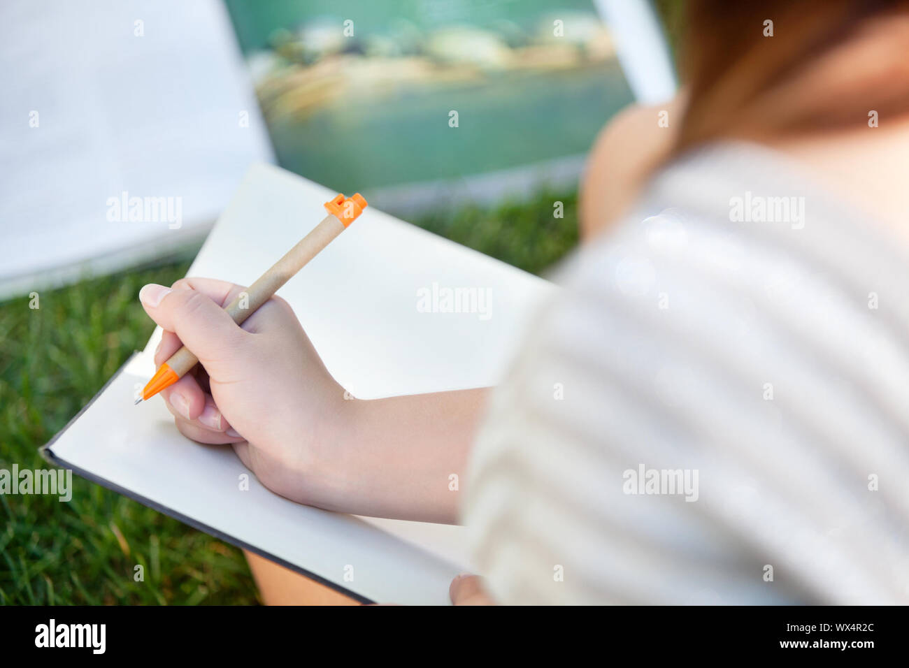 Close-up of a girl writing in a notebook Stock Photo - Alamy