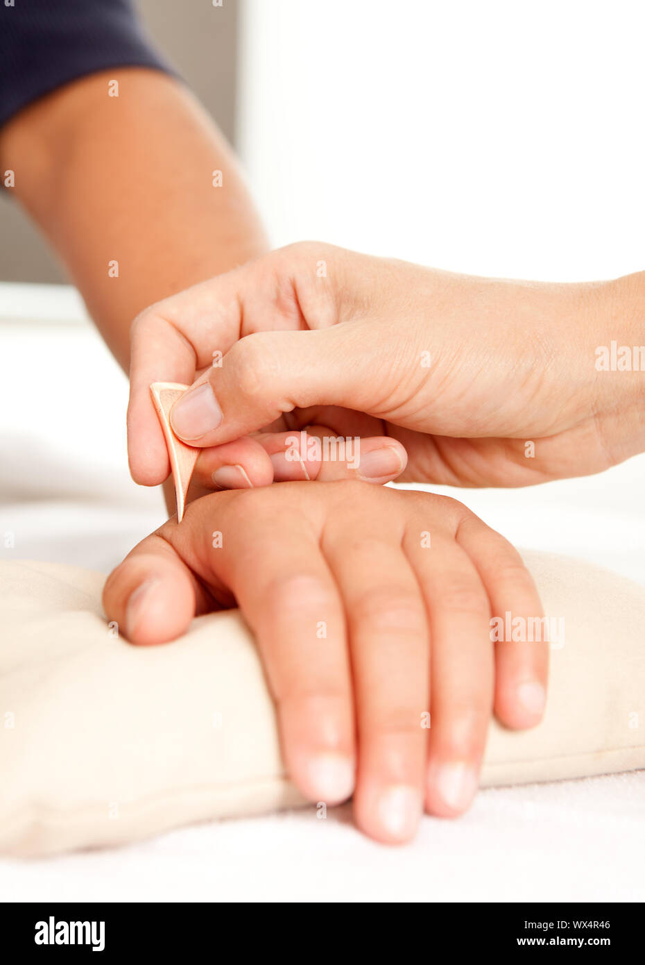 Shonishin acupuncture technique performed on a young male with a ...