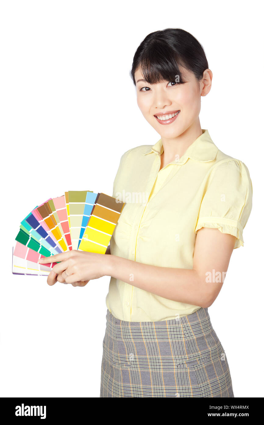 Happy young woman showing color chart isolated on white background ...