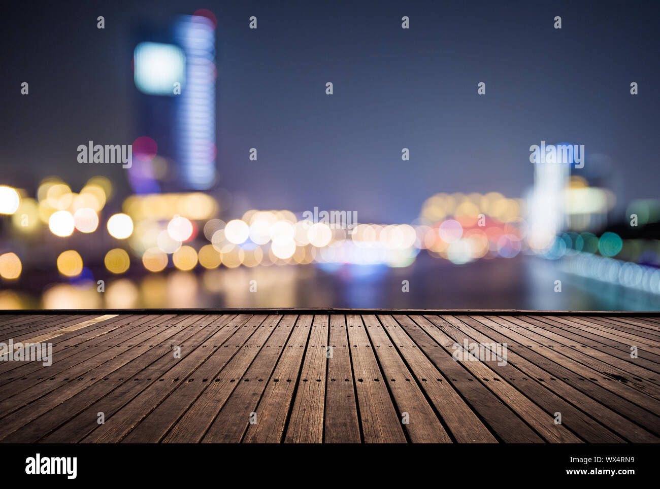 wooden platform and lights of night city Stock Photo - Alamy