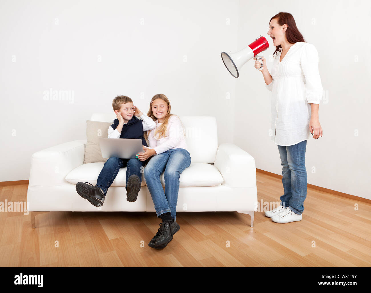 Outrageous mom screaming at kids with laptop using megaphone Stock ...