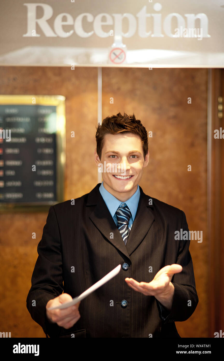 Young man holding an invoice to be delivered to one of the hotel ...
