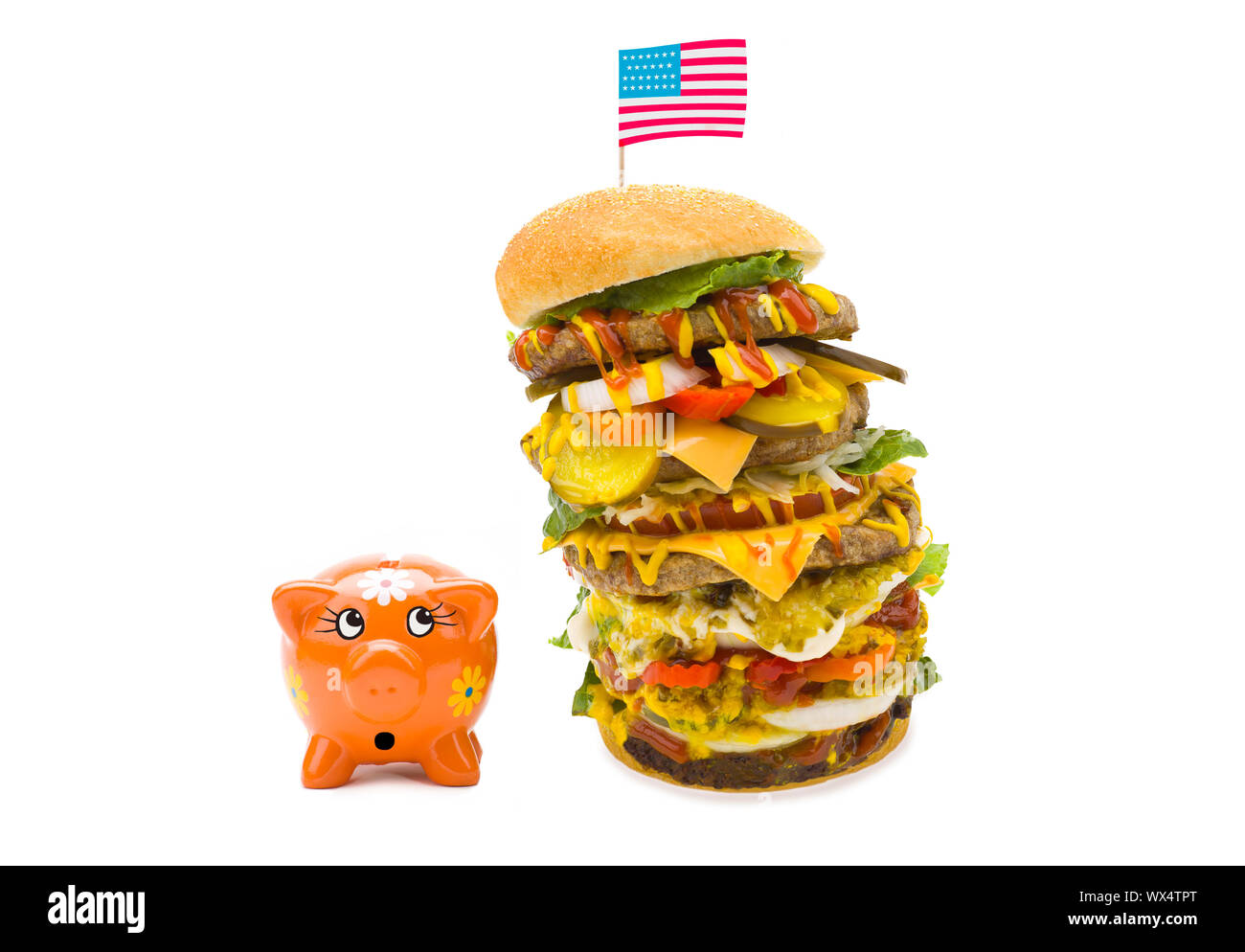 An enormous burger with many layers topped with the American flag Stock ...