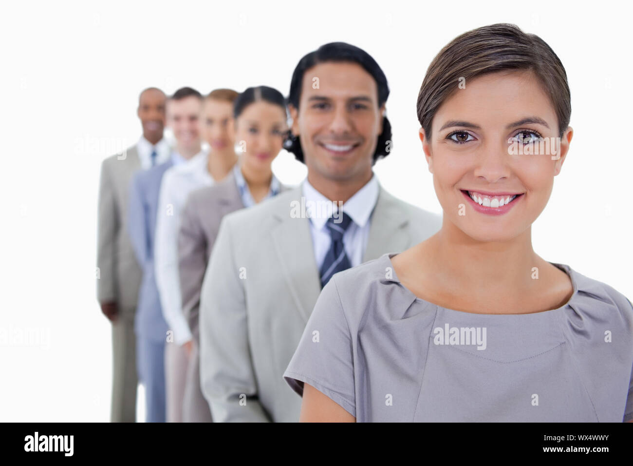Big close-up of colleagues in a single line smiling and looking ...