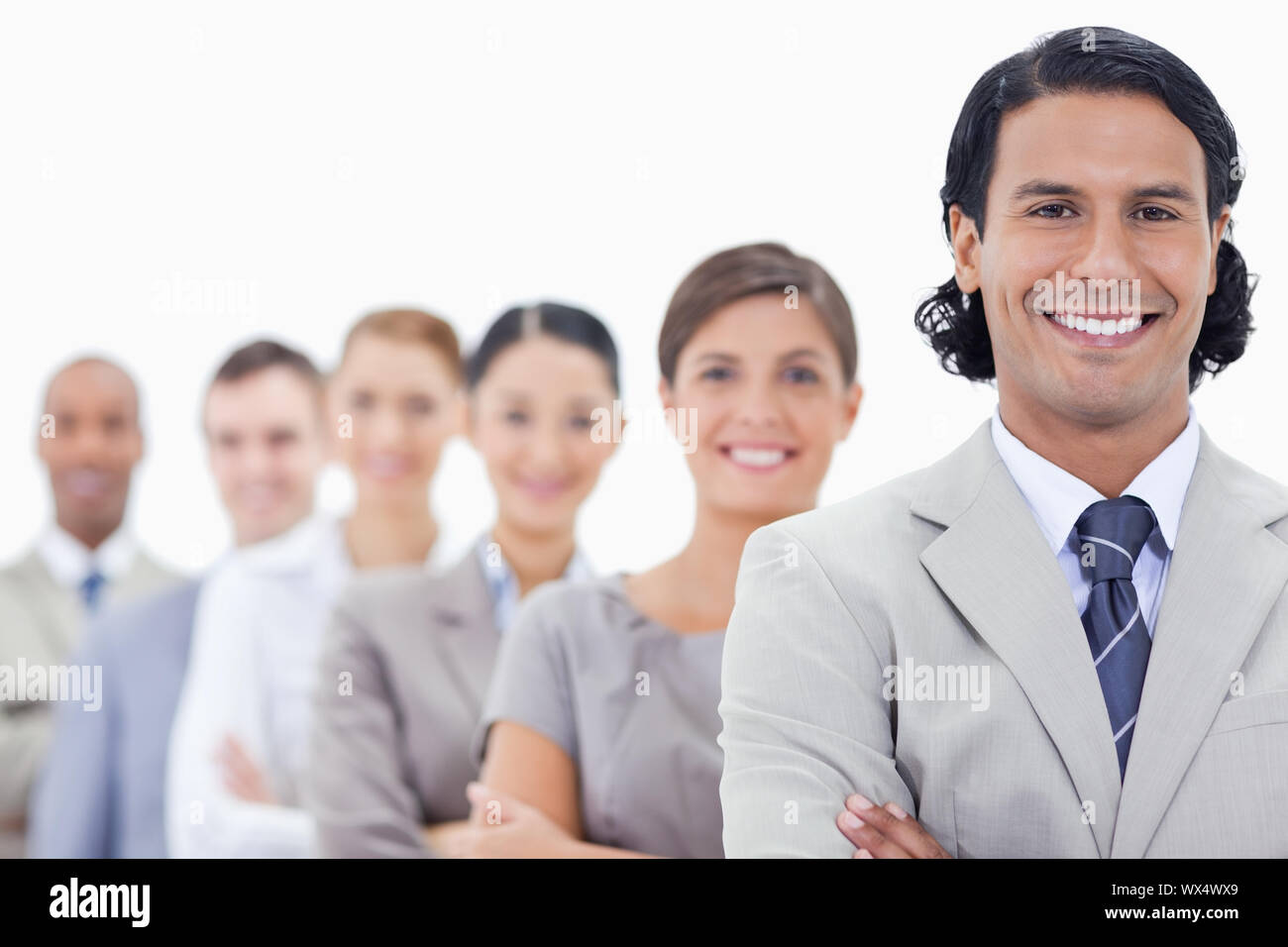 Big close-up of a happy business team crossing their arms in a single ...
