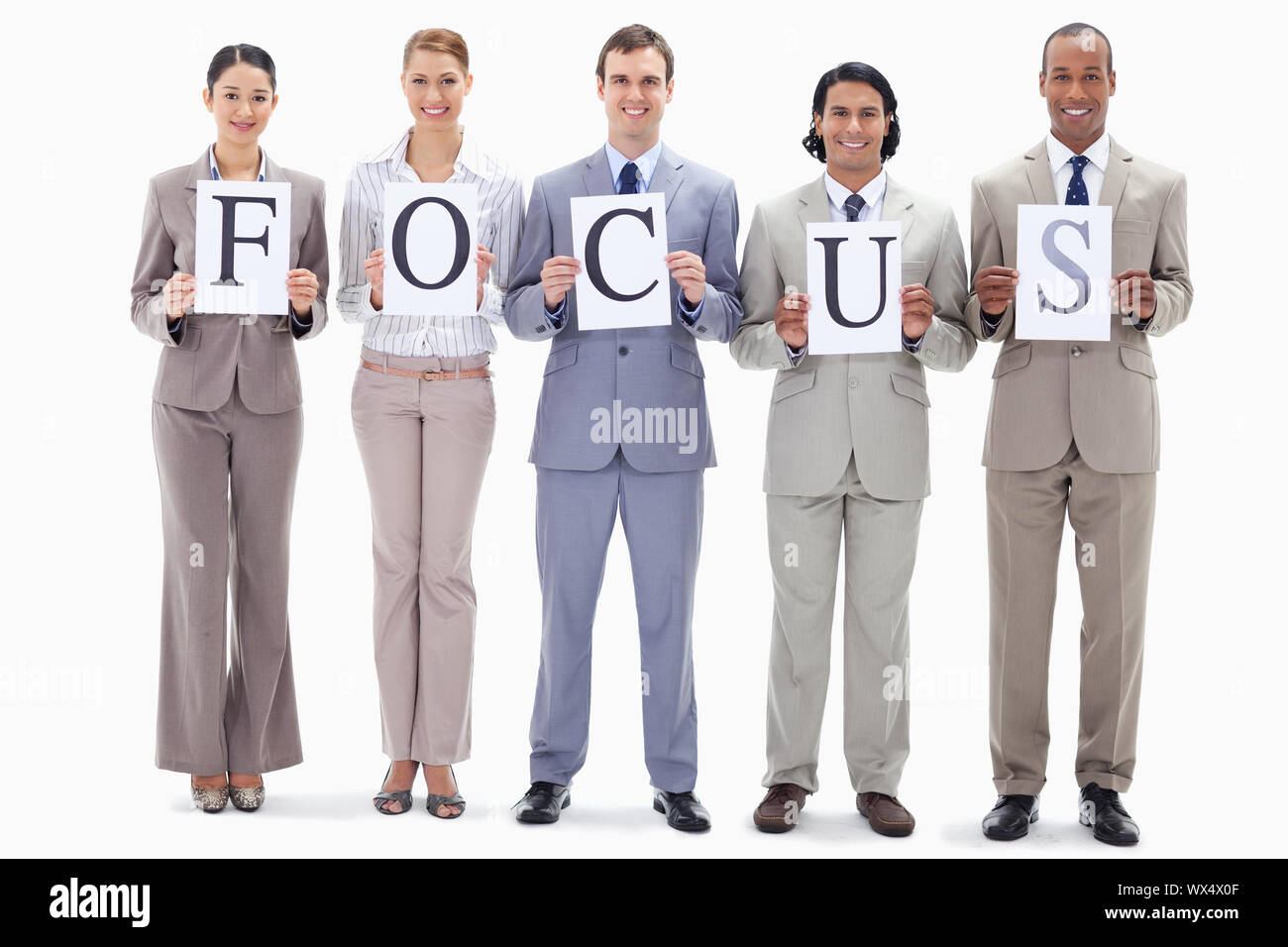 Happy business team holding the letters of FOCUS against white ...
