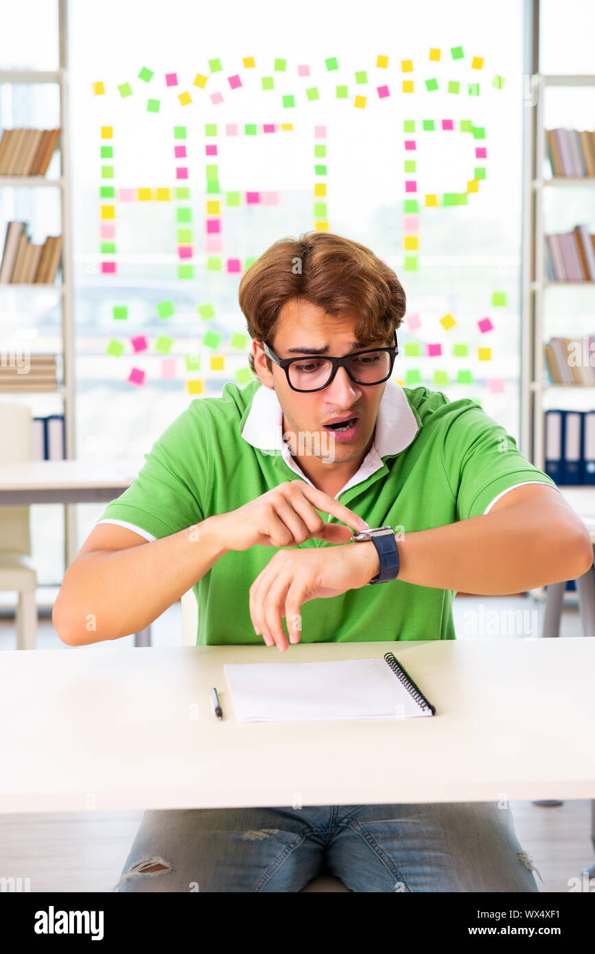 Student struggling at the exam in classroom Stock Photo - Alamy