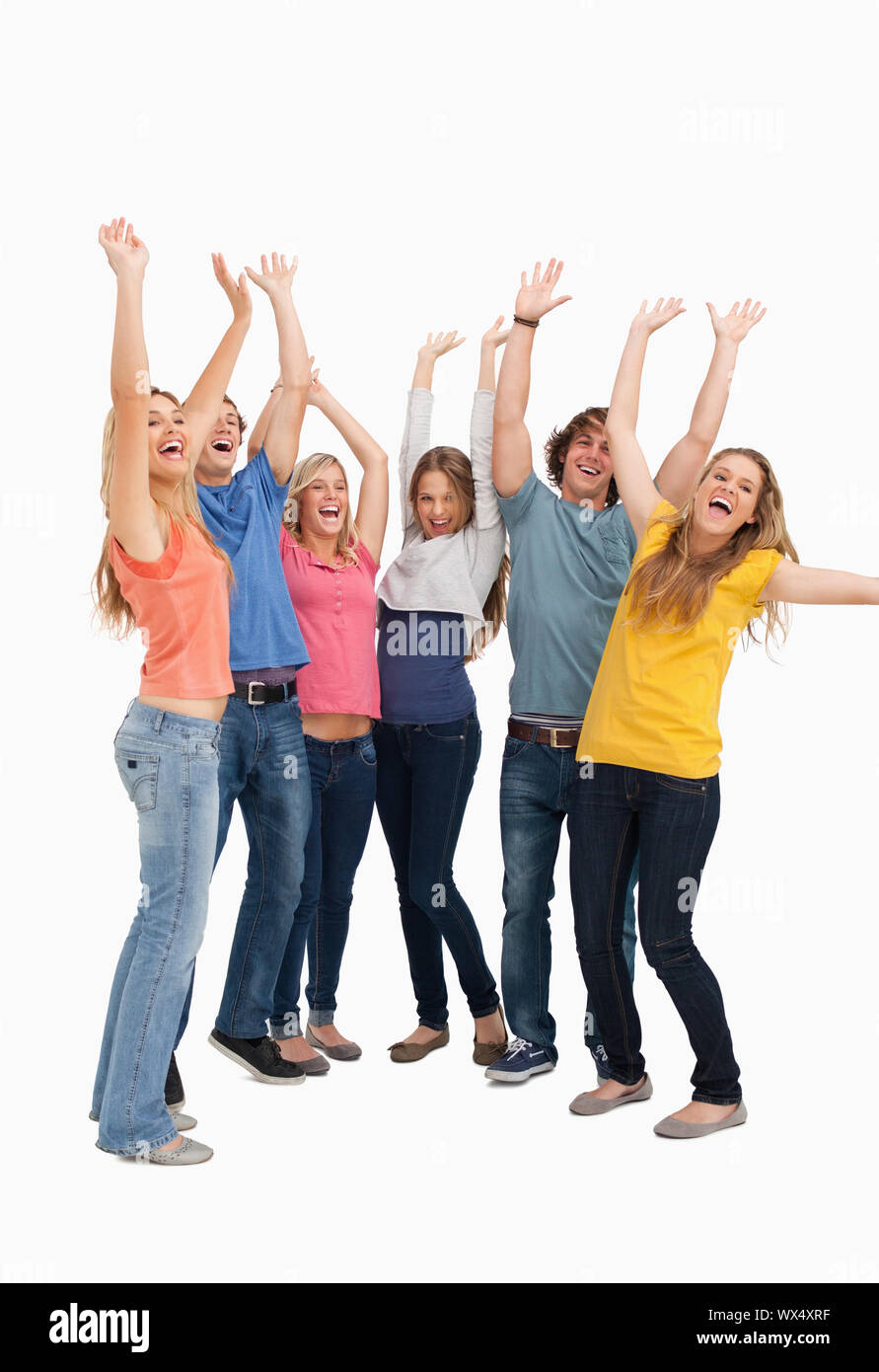 A group looking to the side as they jump in the air while cheering ...