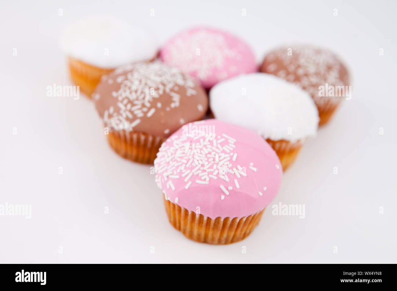Blurred muffins placed in pyramid against a grey background Stock Photo ...
