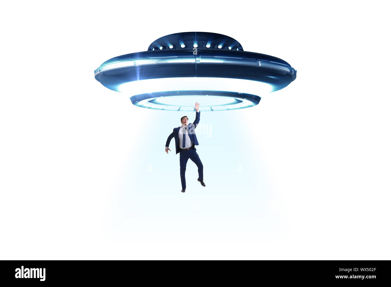 Flying saucer abducting young businessman Stock Photo - Alamy