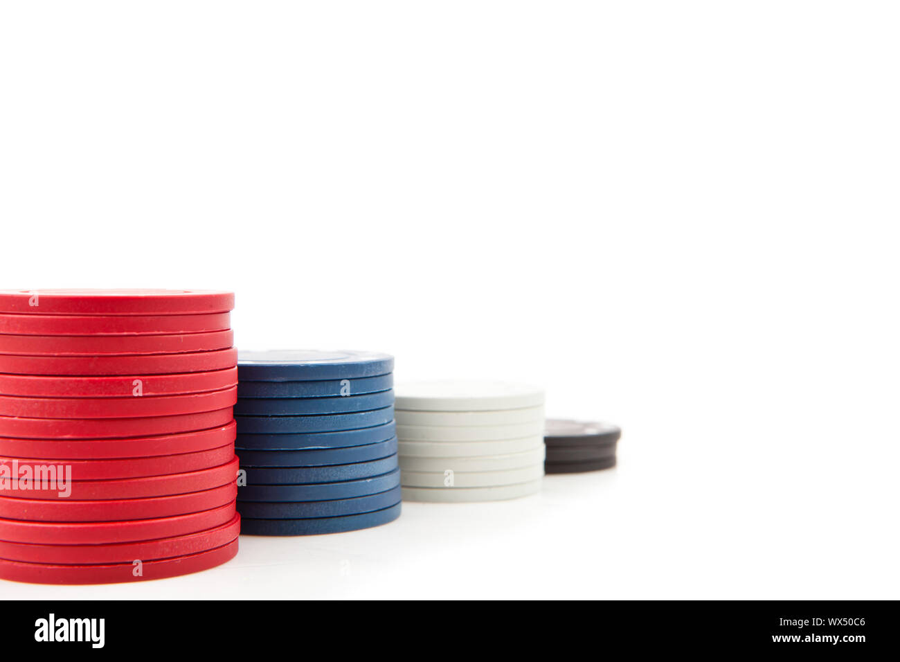 Piles of poker tokens against a white background Stock Photo - Alamy