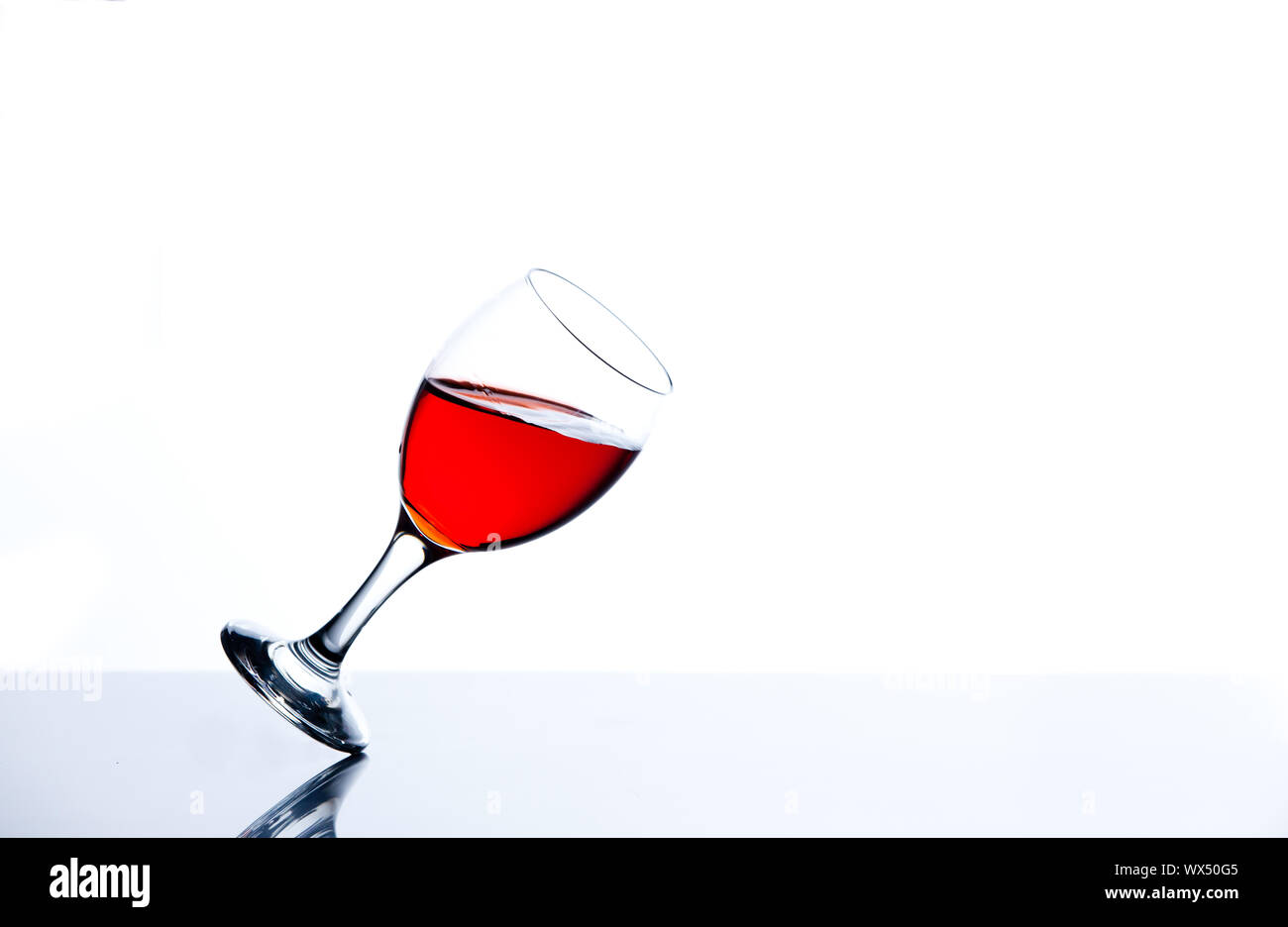 Glass falling against a white background Stock Photo - Alamy