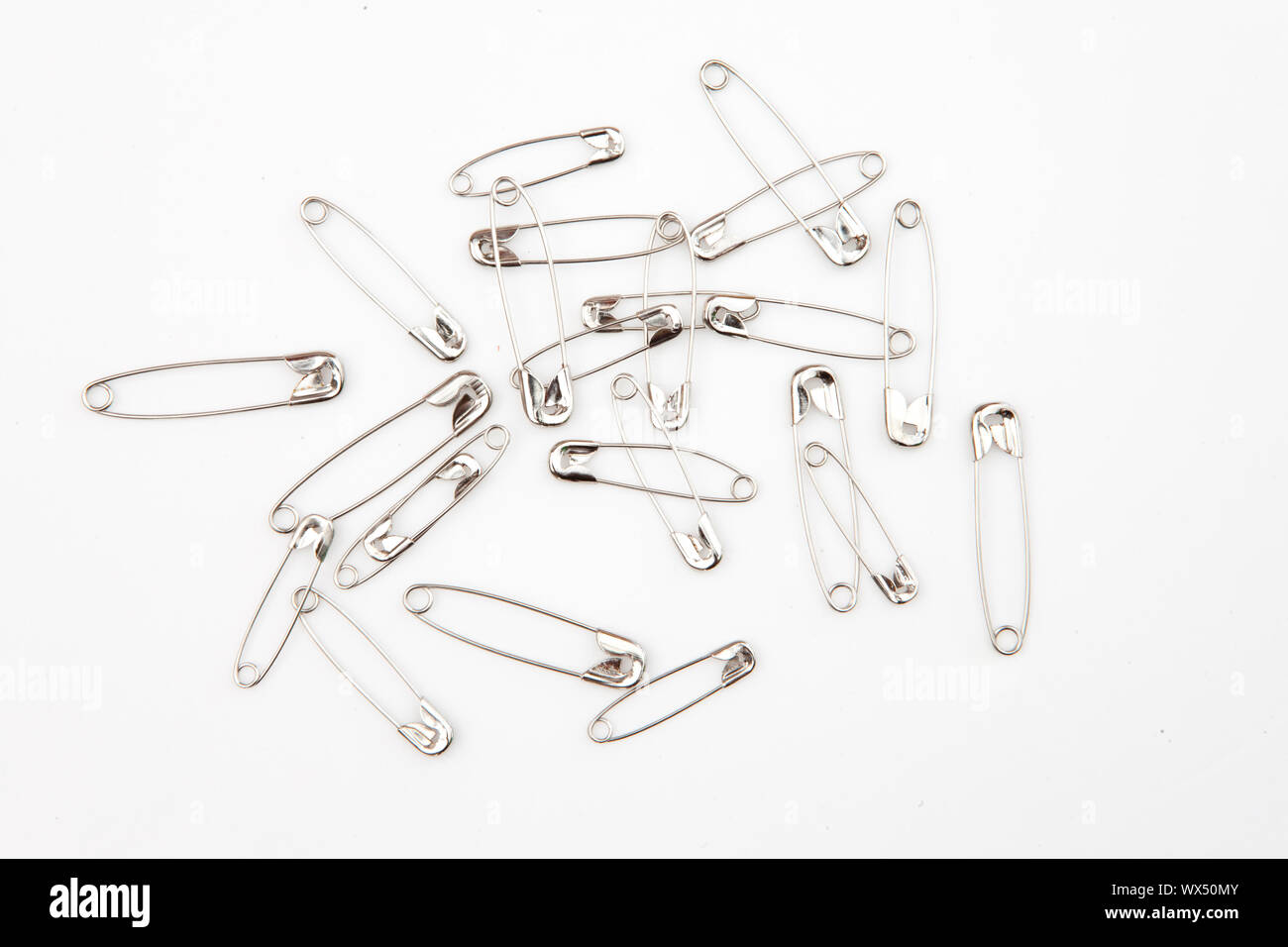 Grey paperclips against a white background Stock Photo - Alamy