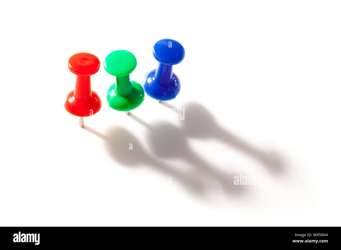 Three push pins against a white background Stock Photo - Alamy