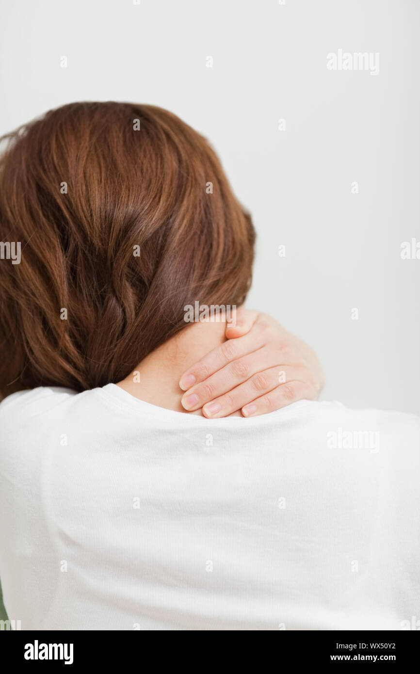 Woman touching painful nape hi-res stock photography and images - Alamy