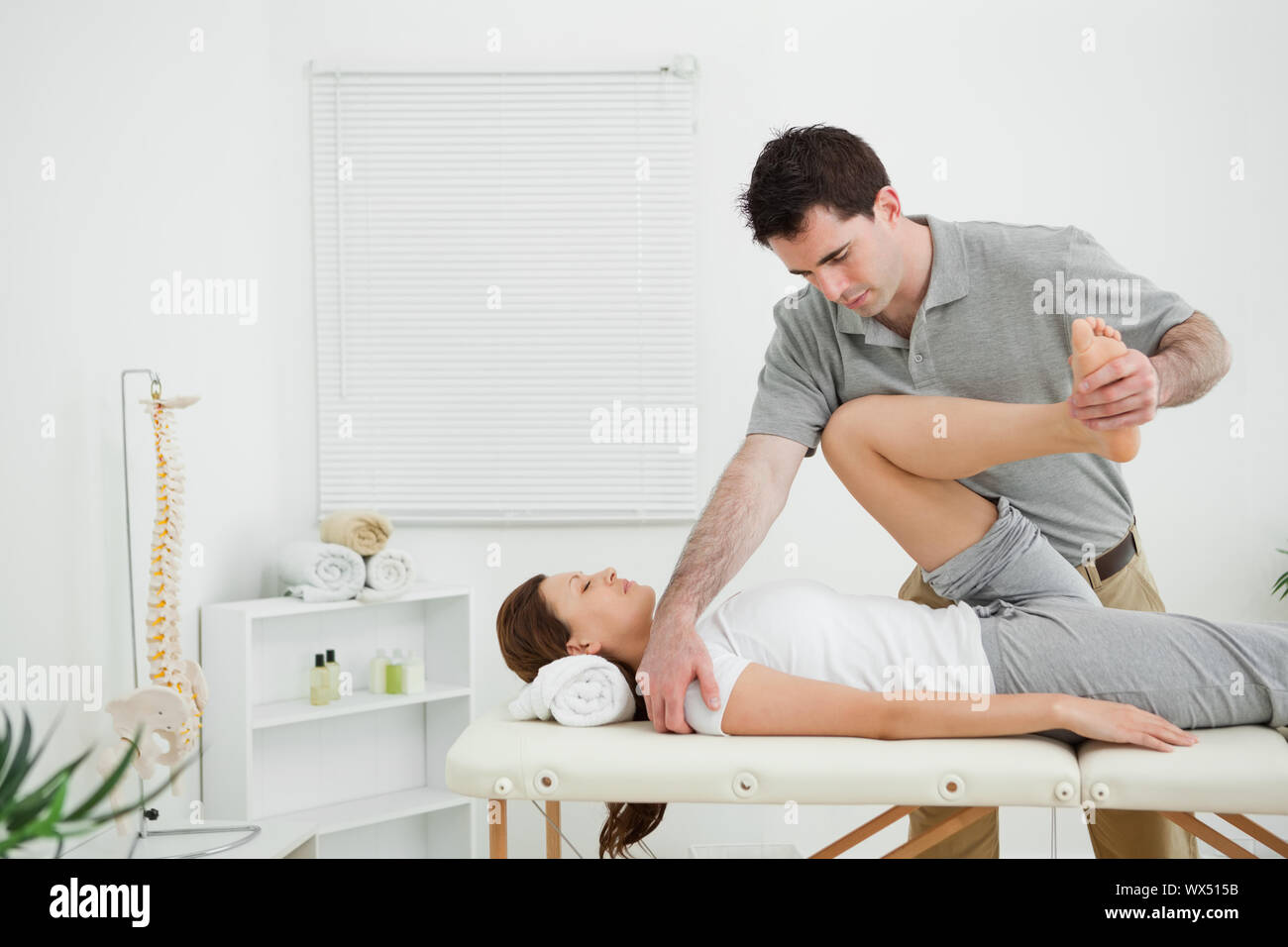Brunette stretching leg standing hi-res stock photography and images ...