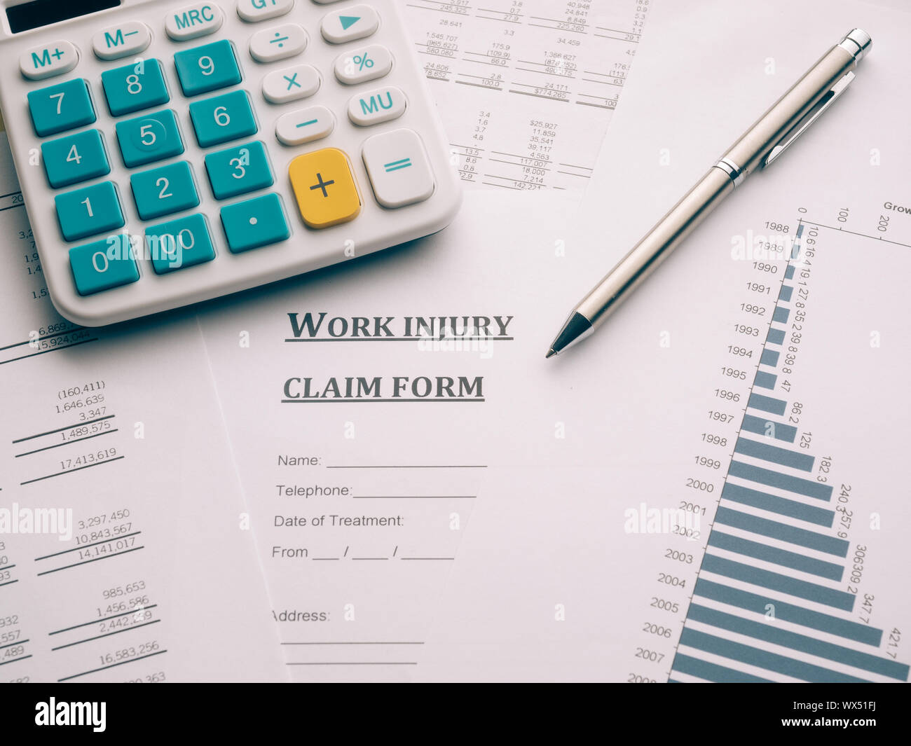 work injury claim form on desk Stock Photo - Alamy