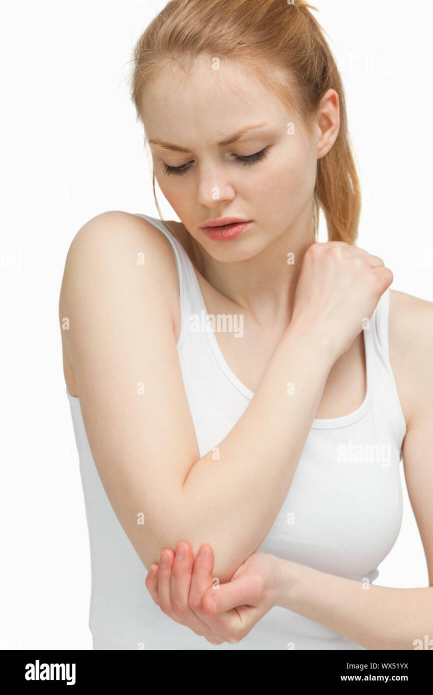 Woman touching her elbow against white background Stock Photo - Alamy