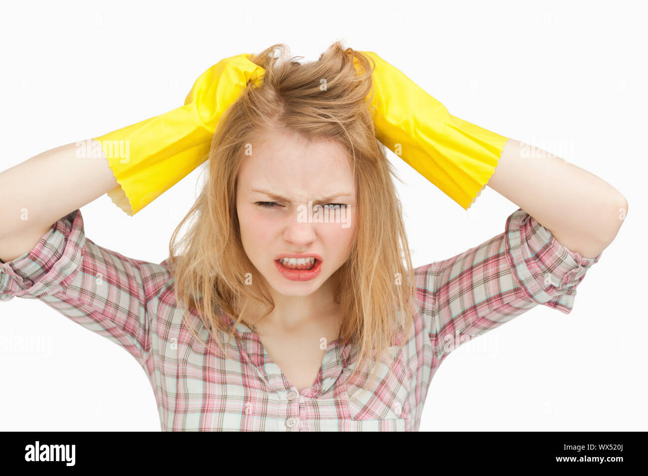 Woman pulling her hair against white background Stock Photo - Alamy