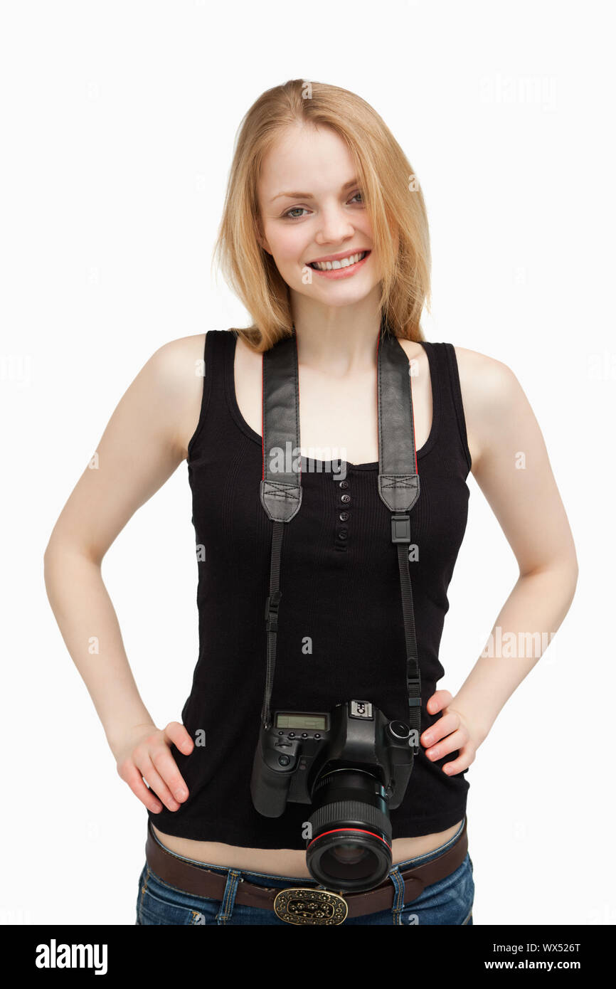 Joyful woman carrying a camera against white background Stock Photo - Alamy