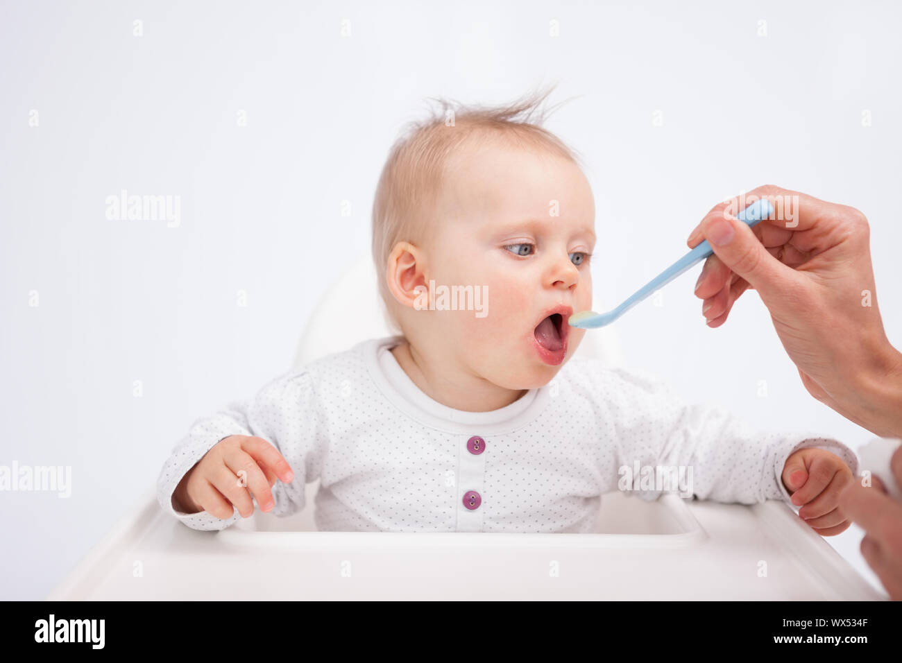 Baby girl being fed hi-res stock photography and images - Alamy