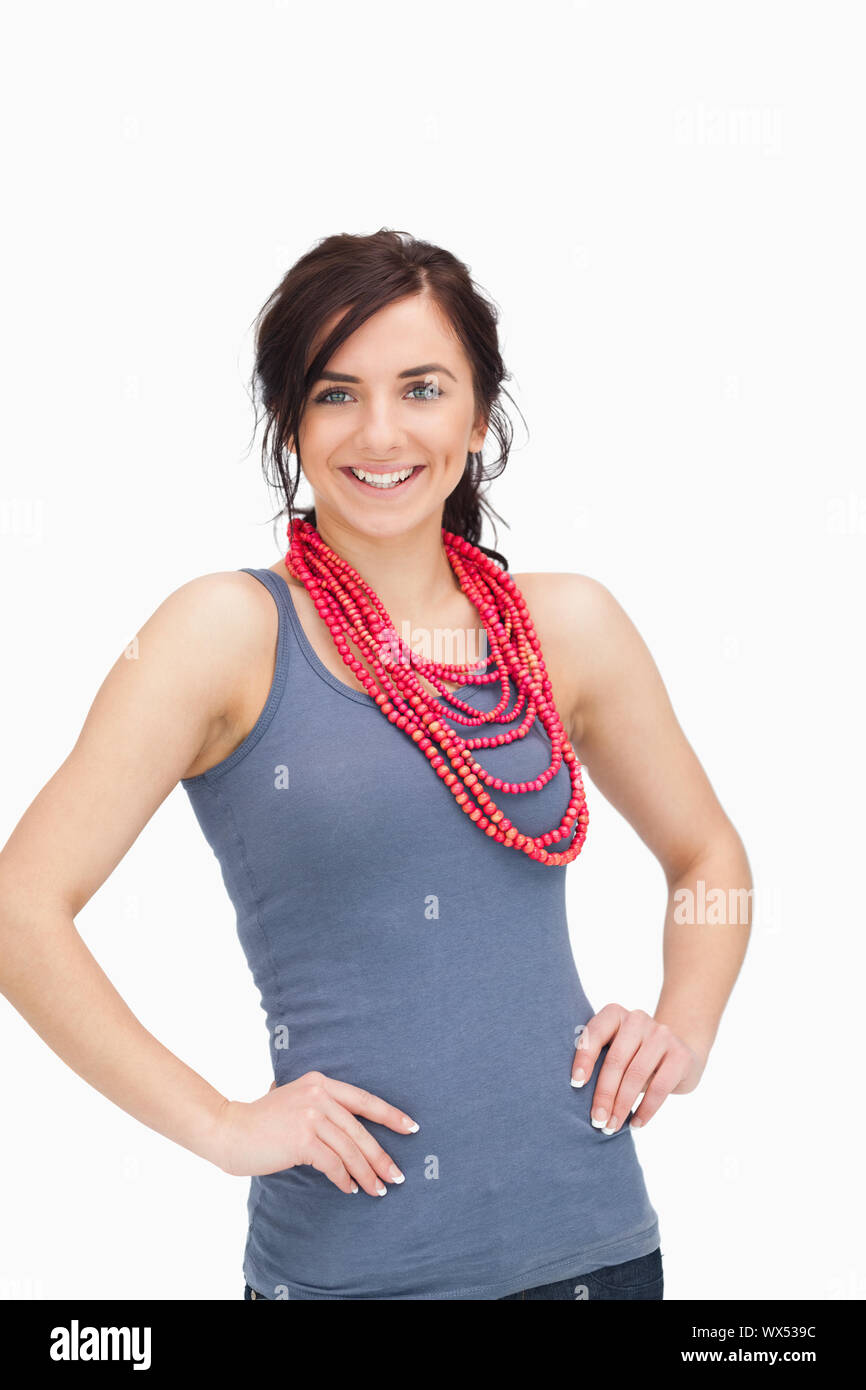 Smiling woman hands on her hips against white background Stock Photo ...