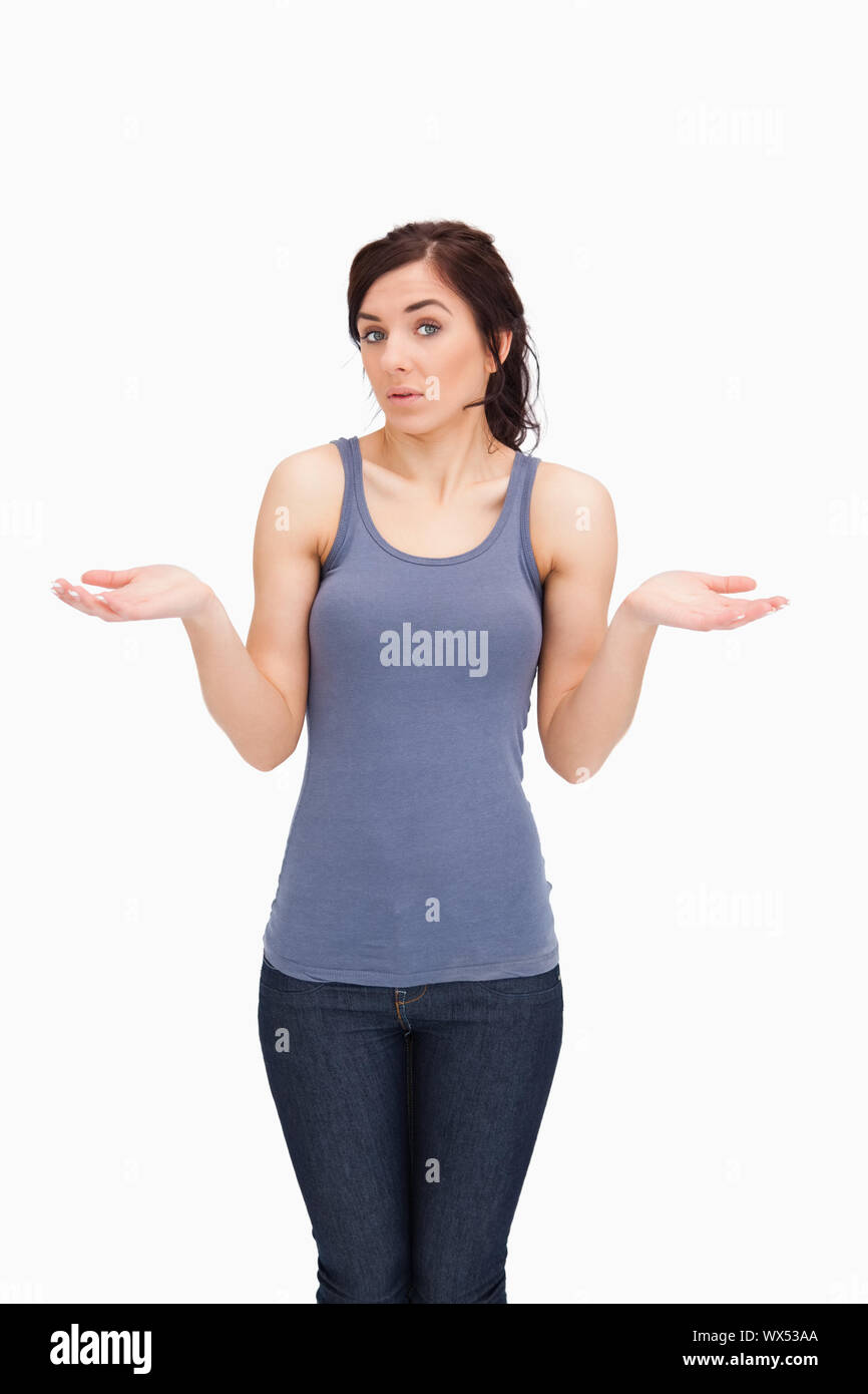 Clueless female student against white background Stock Photo - Alamy
