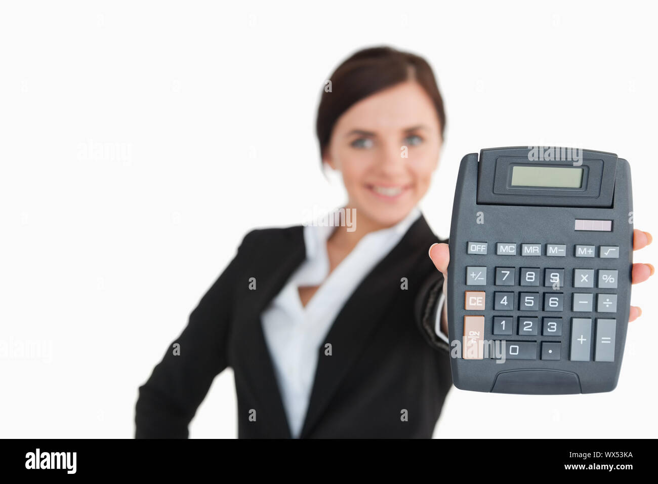 Woman in black suit showing a calculator against white background Stock ...