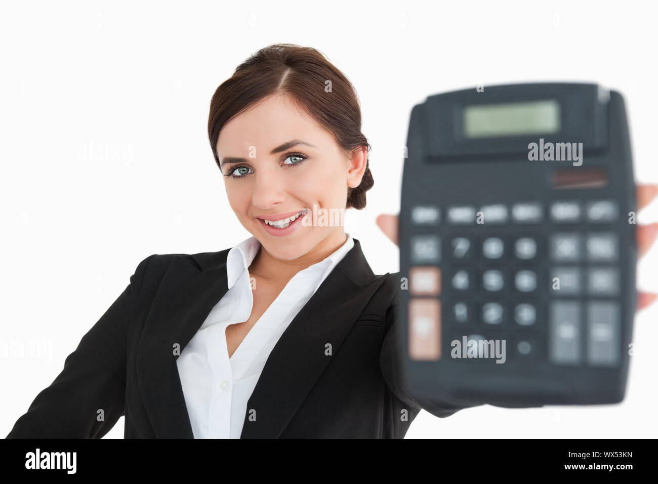 Smiling woman in black suit showing a calculator against white ...