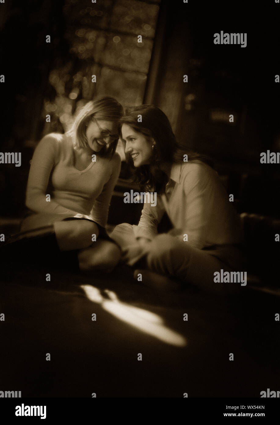 Two women sharing secrets Stock Photo - Alamy