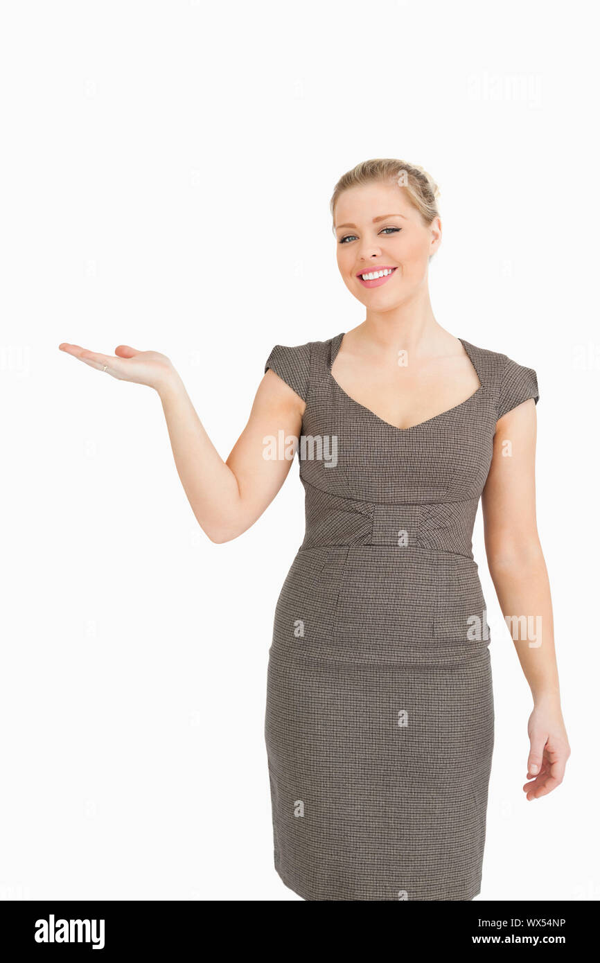 Pretty woman presenting something with her hand against white ...
