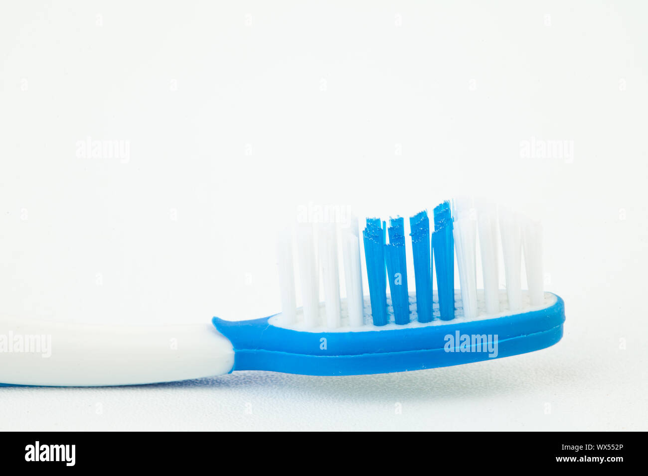 Blue toothbrush against white background Stock Photo - Alamy