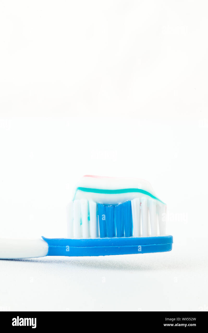 Toothpaste on a toothbrush against white background Stock Photo - Alamy