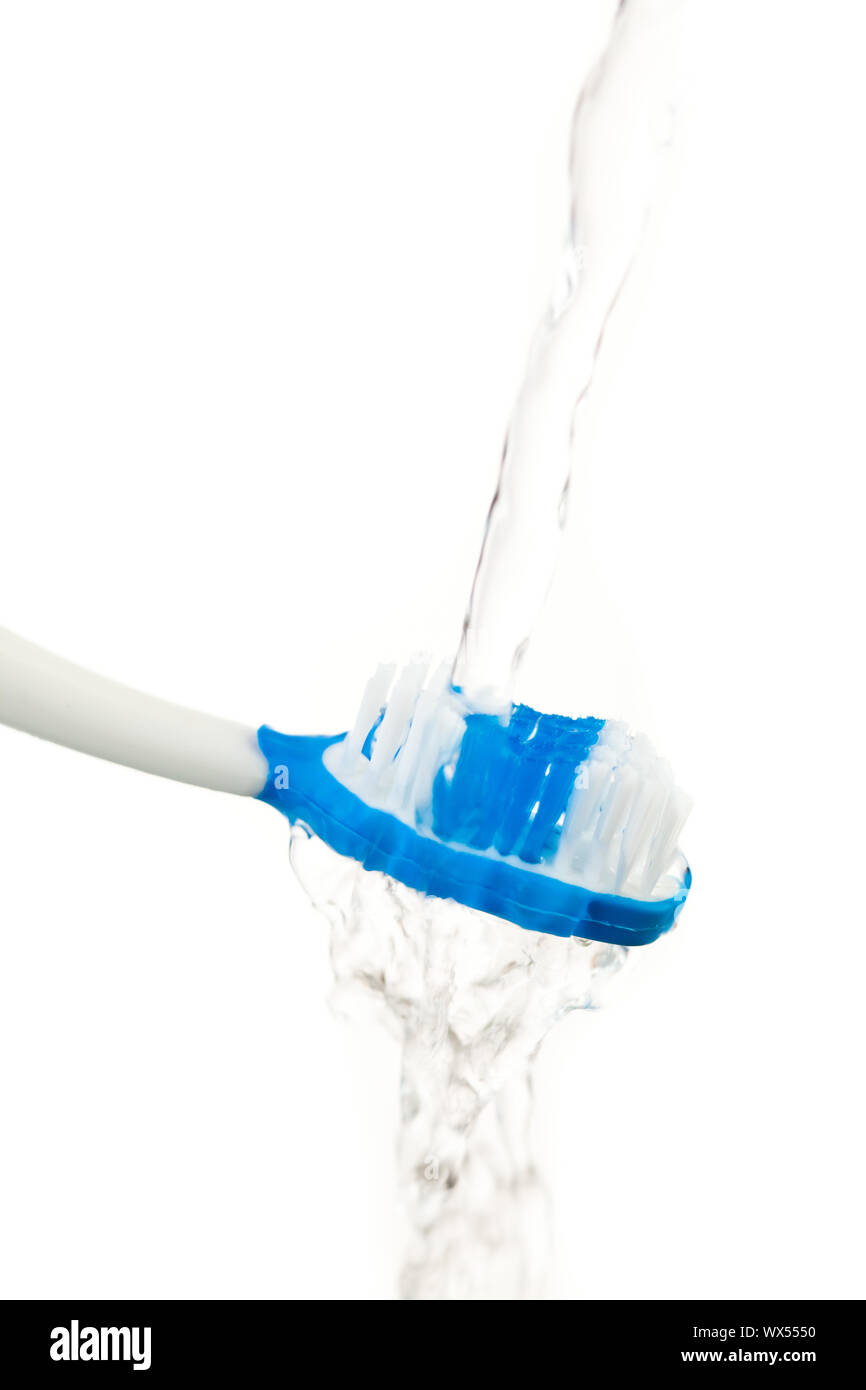 Water flowing on a toothbrush against white background Stock Photo - Alamy
